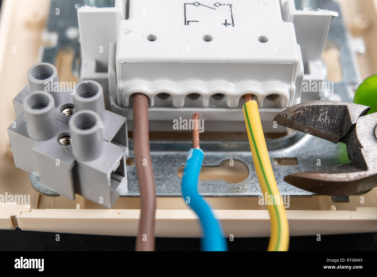 Electrical wires mounted to an electrical outlet. Electrical ...
