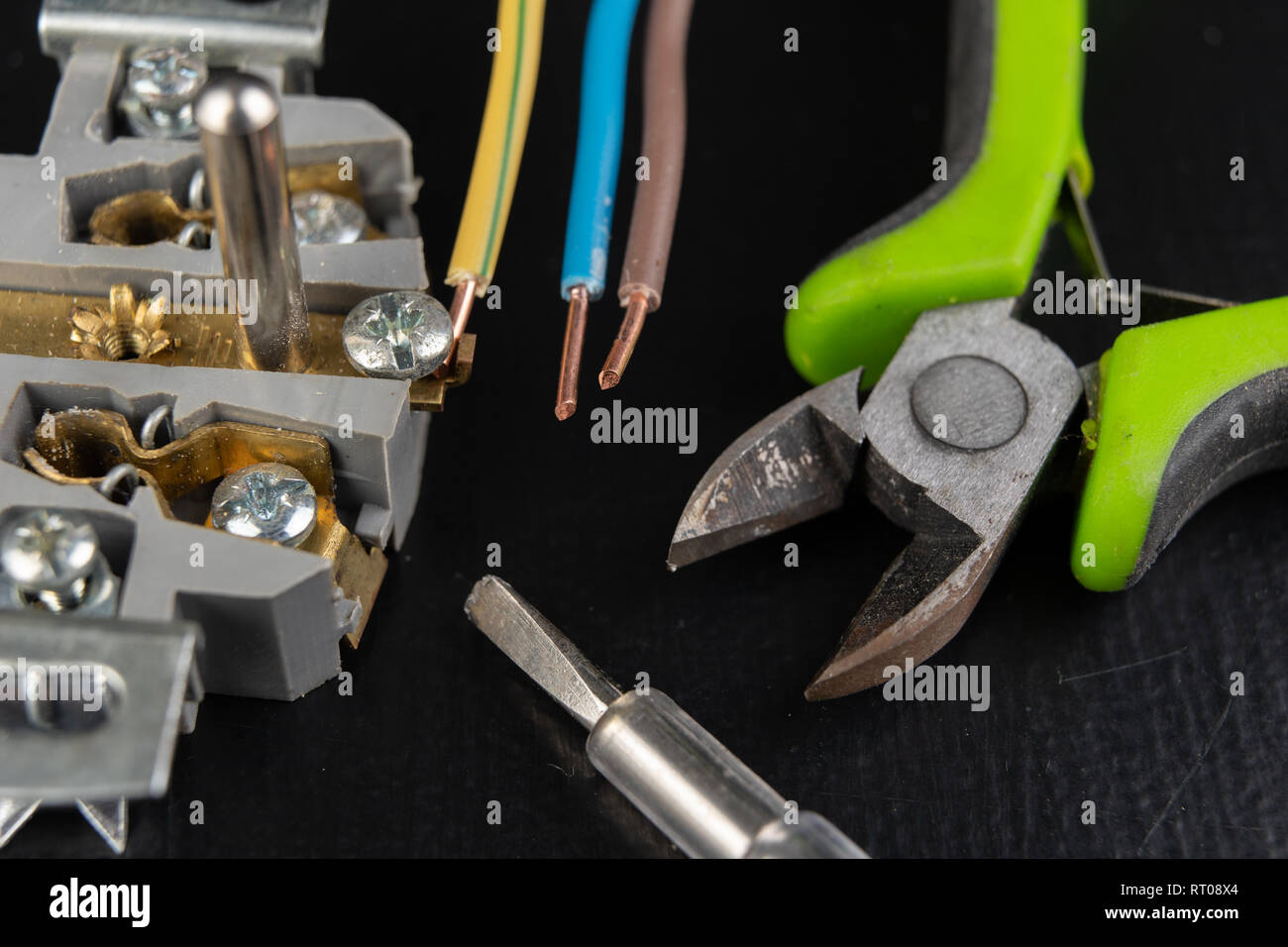 Electrical wires mounted to an electrical outlet. Electrical ...