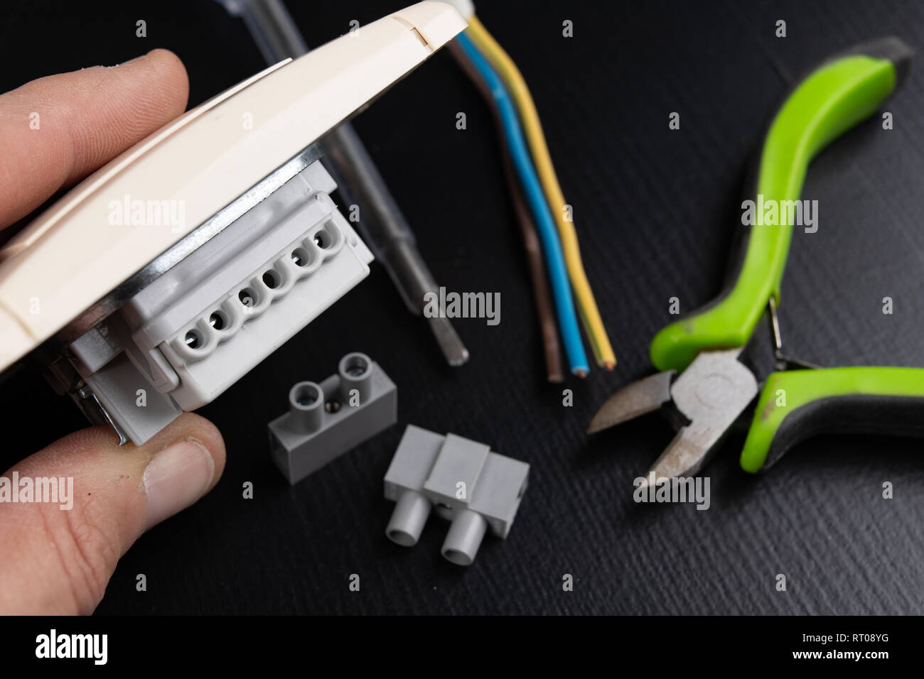 Electrical wires mounted to an electrical outlet. Electrical ...