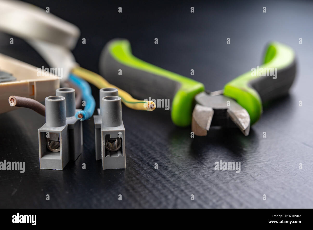 Electrical wires mounted to an electrical outlet. Electrical ...