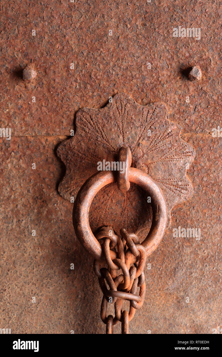 Rust metallic massive door with ring and rusted chain Stock Photo - Alamy