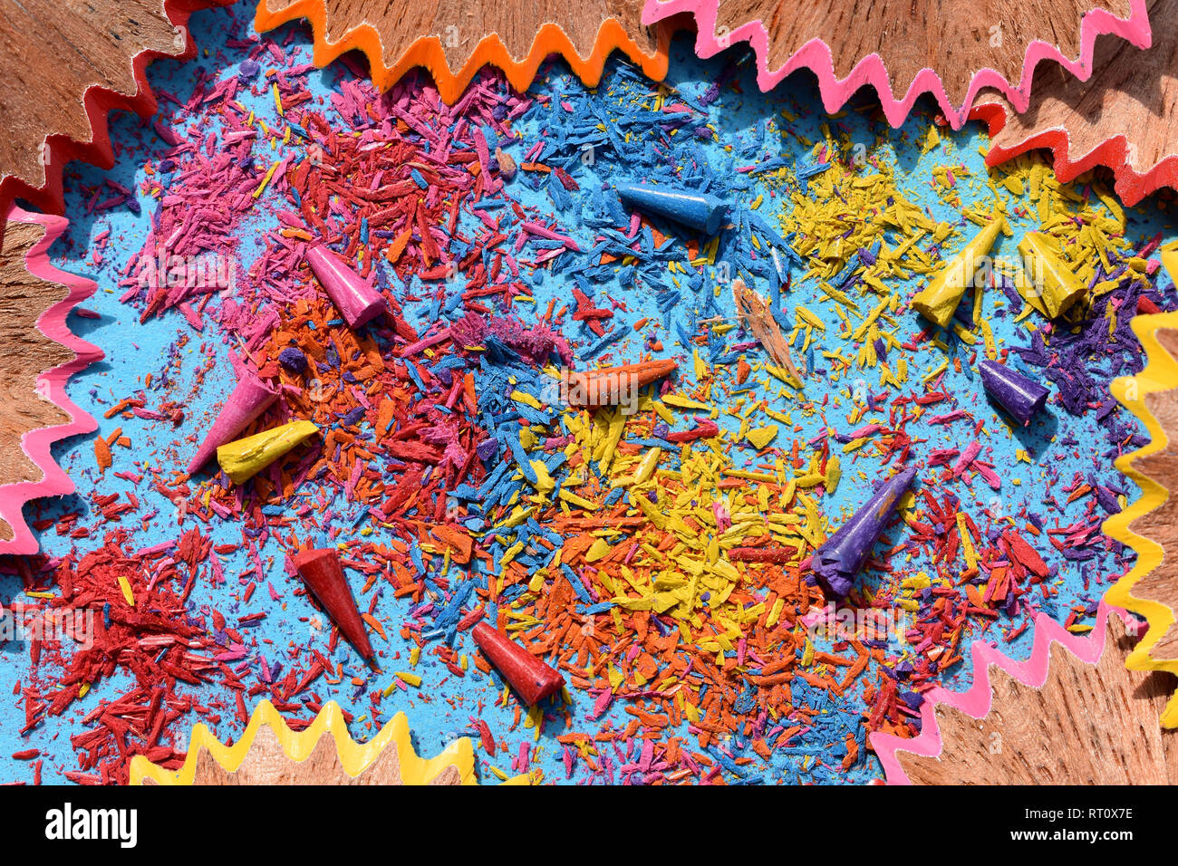 Colored lead and pencil shavings on blue background Stock Photo - Alamy