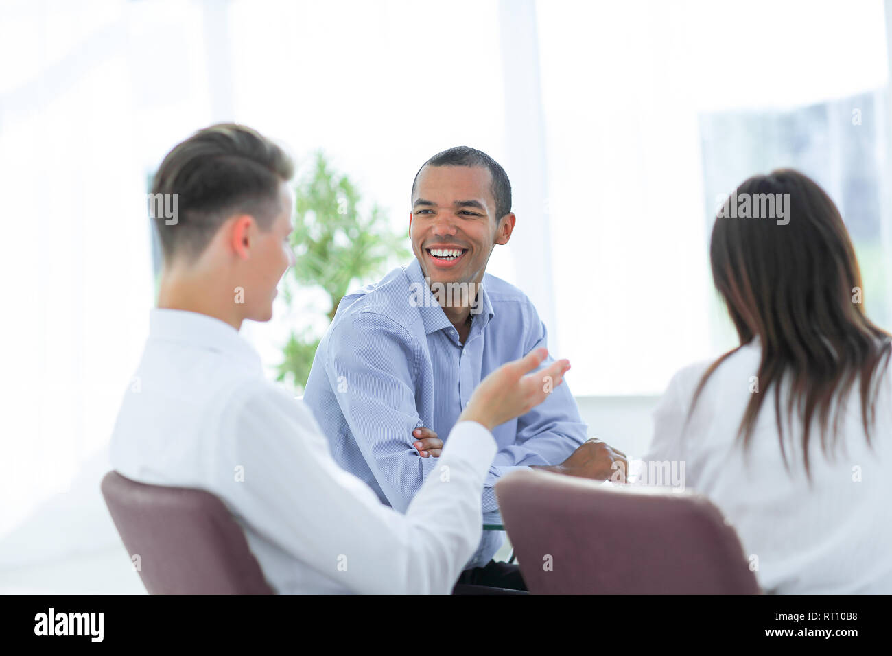 closeup.business team talking sitting in the office Stock Photo - Alamy