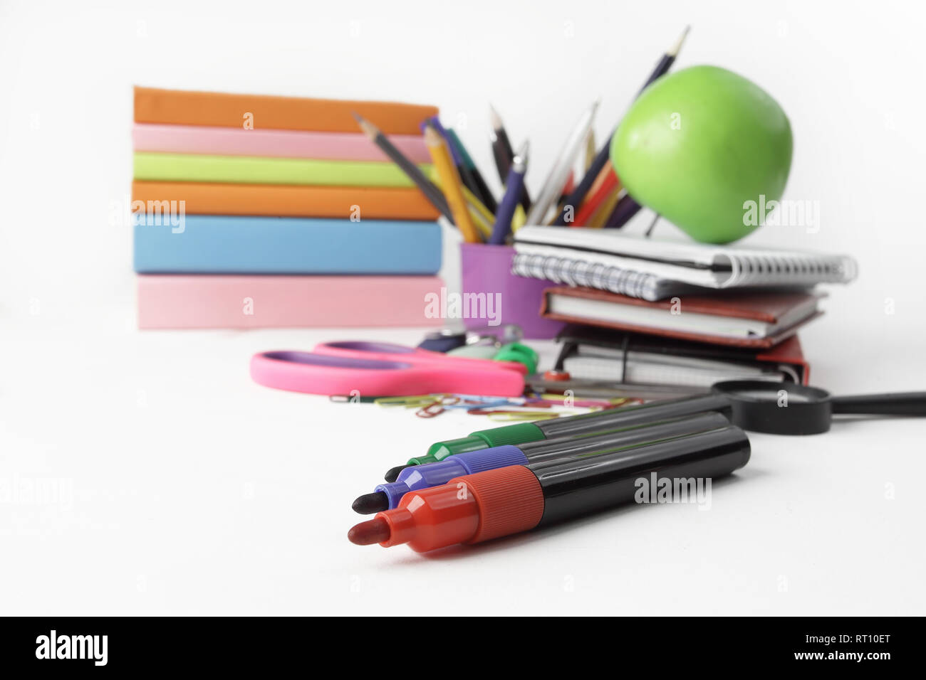 colored markers and school supplies on a white background .concept of ...