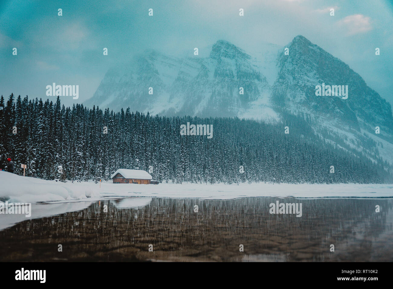 Winter mountain reflection in the calm clear water at Lake Louise in ...