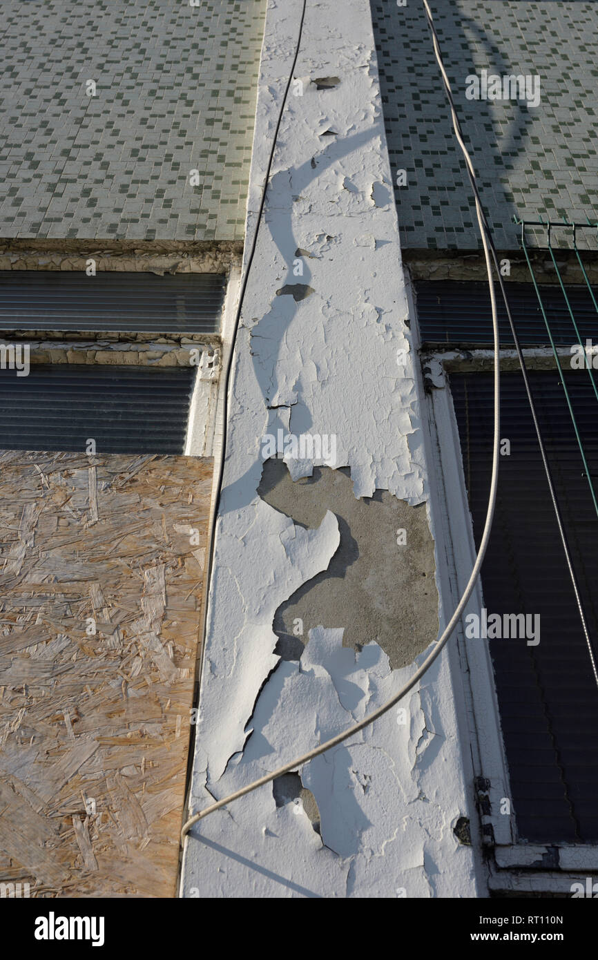 Peeling paintwork, close up on concrete column of Disused and derelict ...