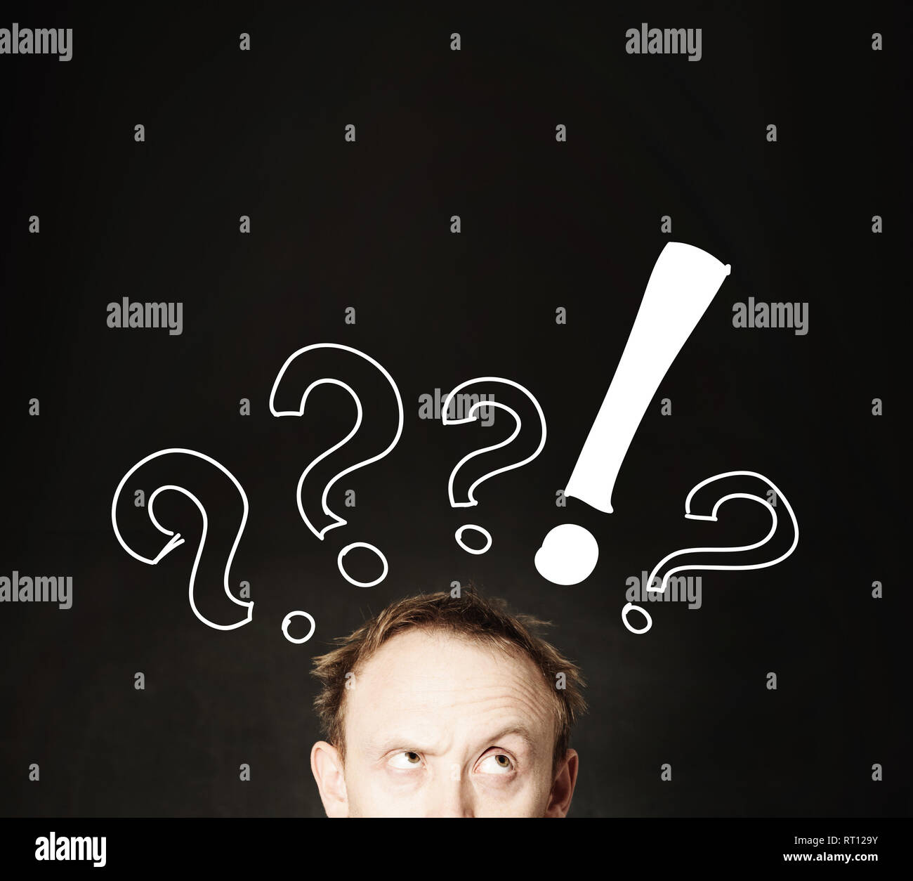 Funny man face with hand drawing question marks on blackboard ...