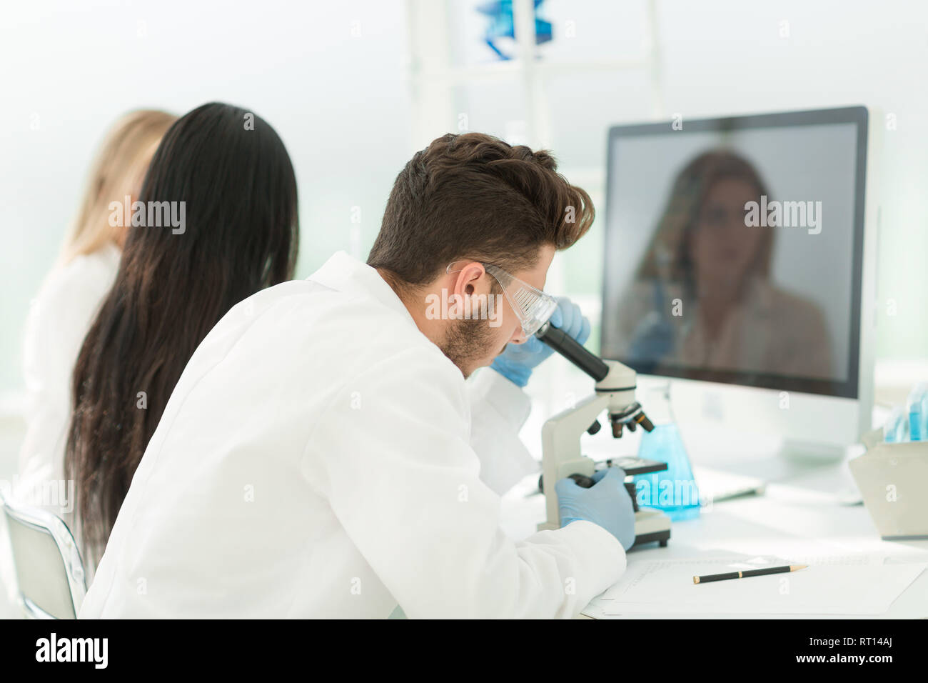 close up.male scientist sitting at a lab table Stock Photo - Alamy