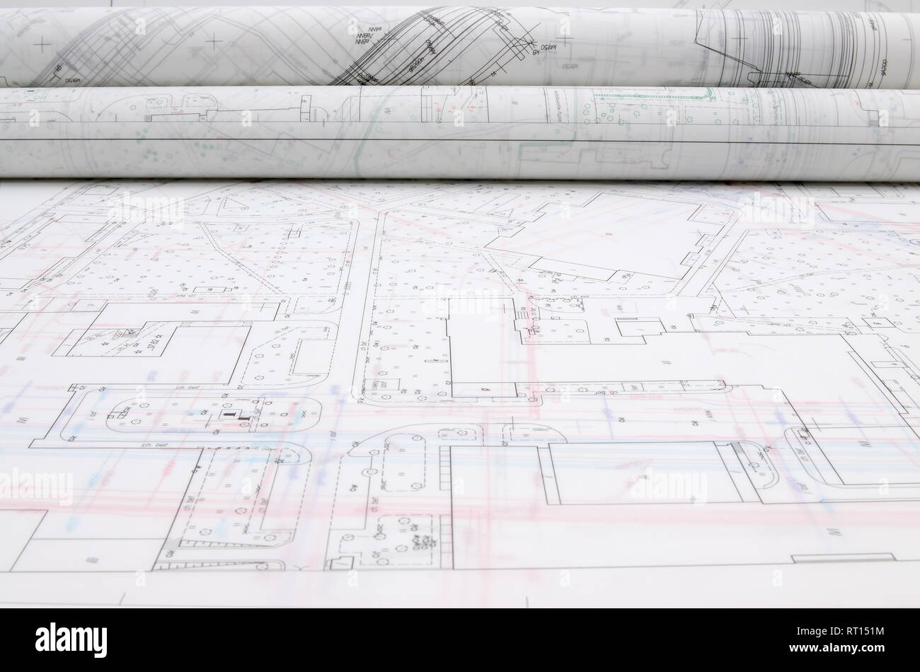 Rolled architectural plans lying on drawing board Stock Photo - Alamy