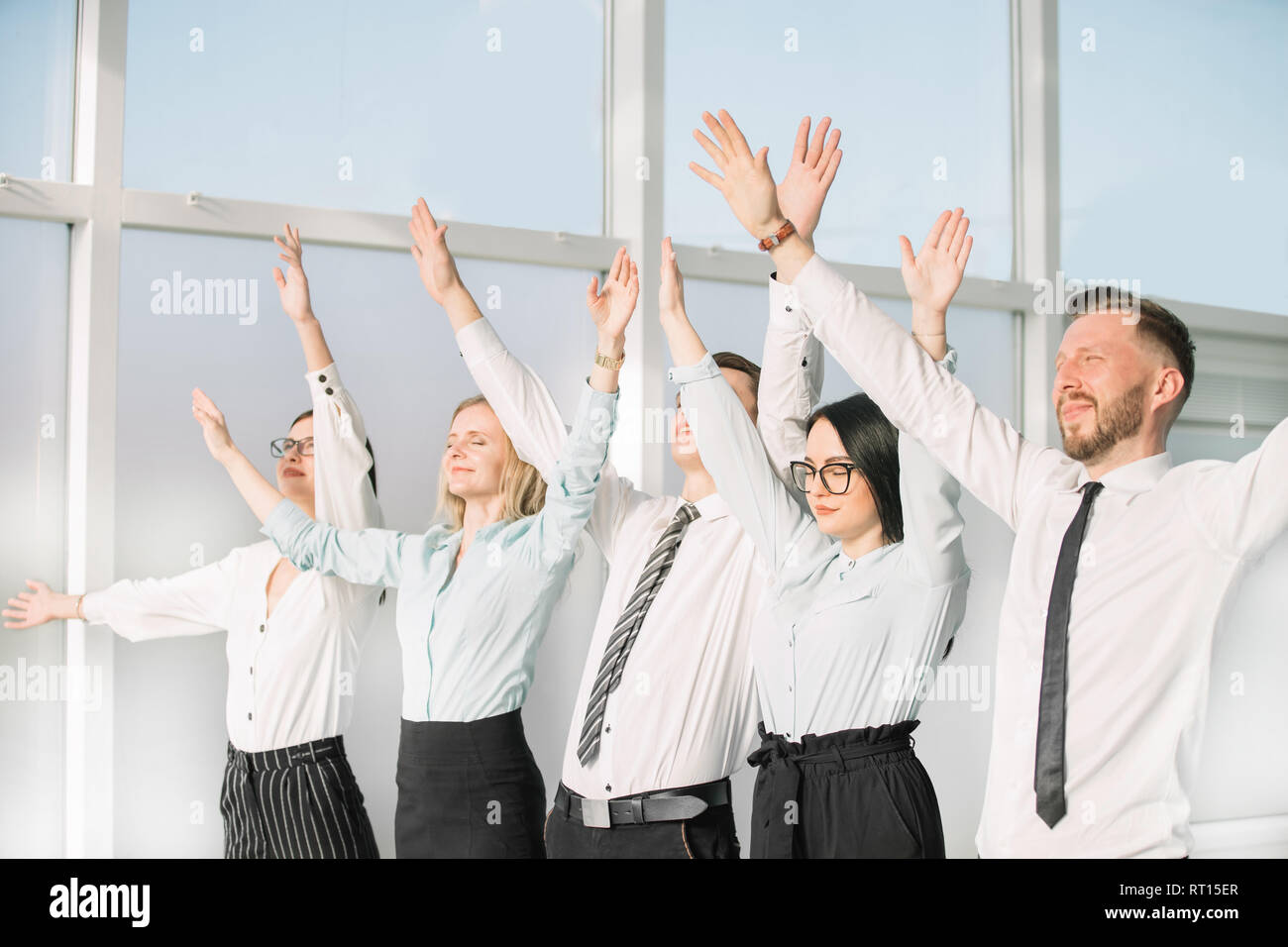 business team showing their success with hands up Stock Photo - Alamy