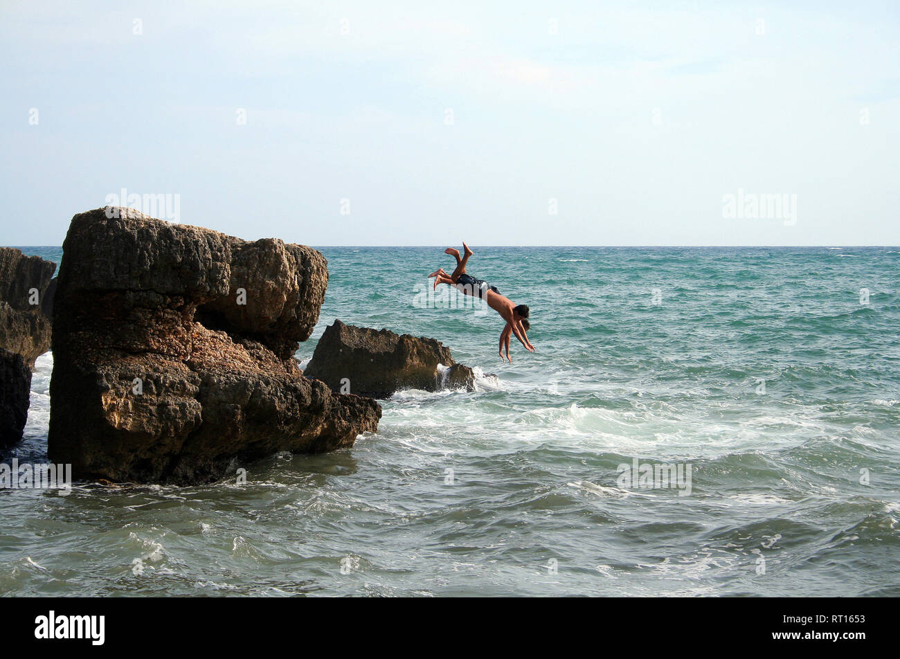 two men jumping into the water in Croatia Stock Photo - Alamy