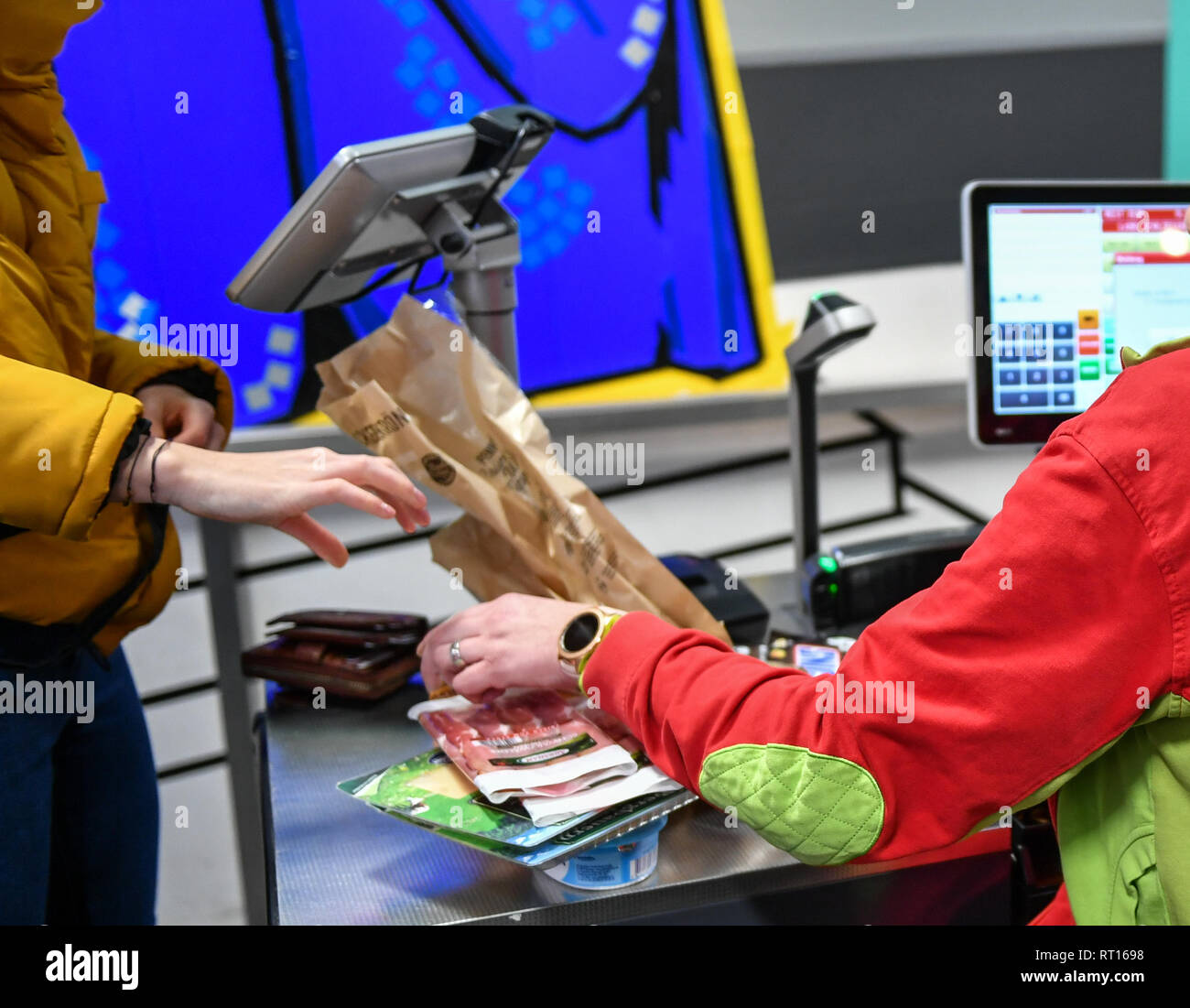 Berlin, Germany. 22nd Feb, 2019. A cashier and a customer at the ...
