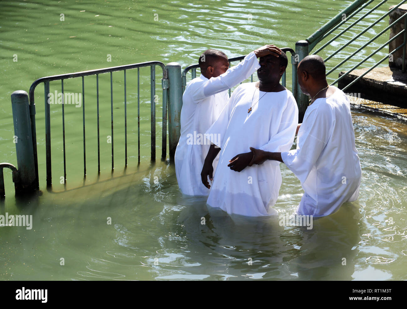 Nigerian pilgrims being baptized at Yardenit on the Jordan river in ...