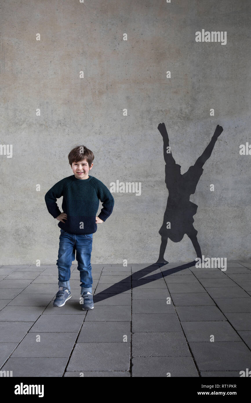 Germany, Duesseldorf, portrait of smiling little boy and shadow of ...