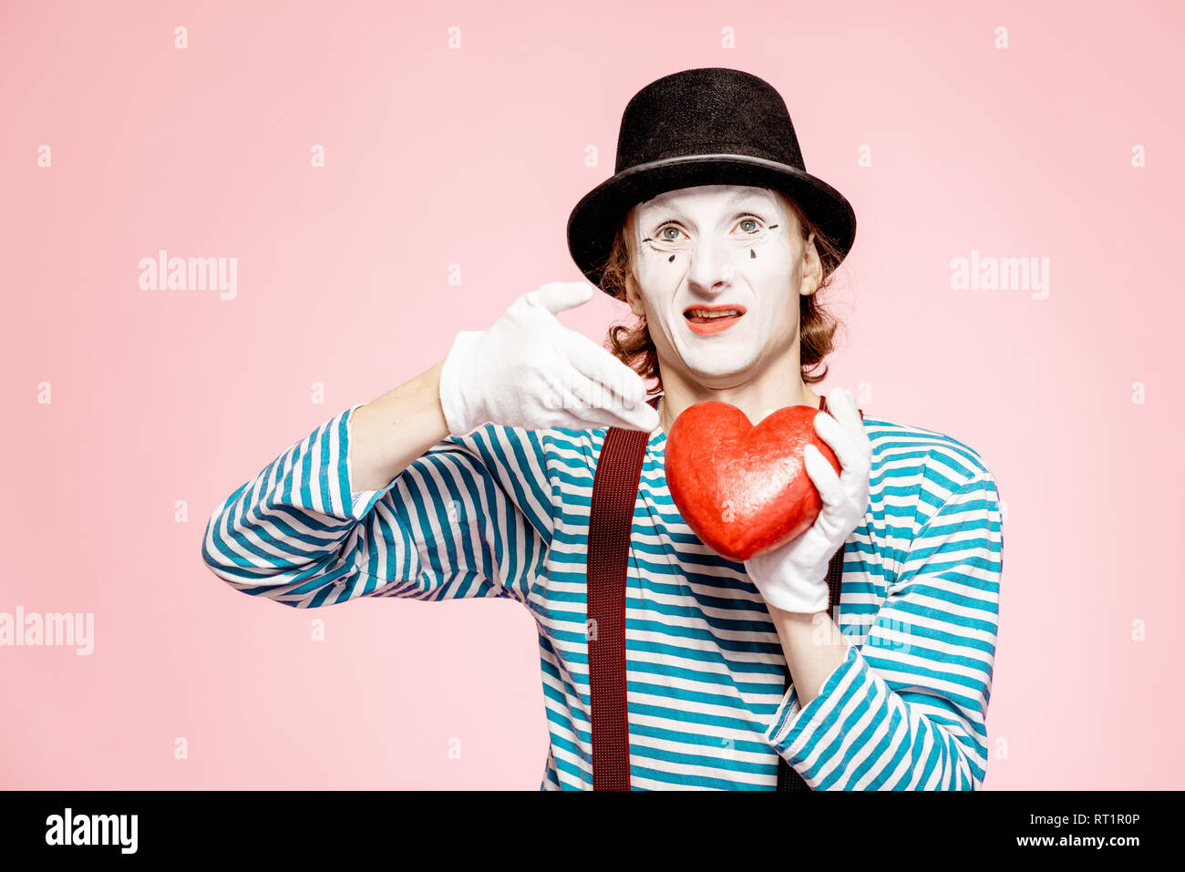 Portrait of an actor as a pantomime with white facial makeup posing ...
