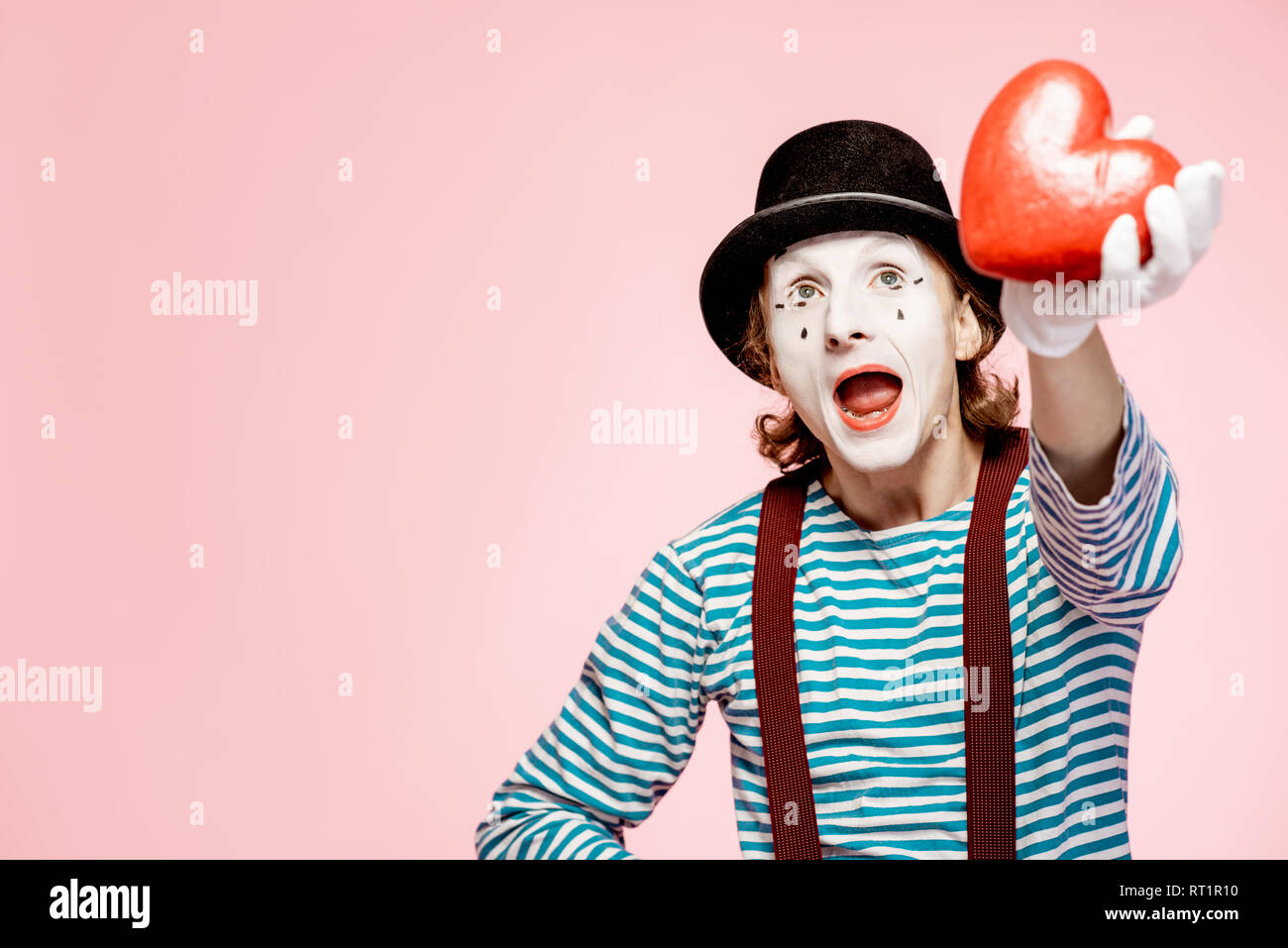 Portrait of an actor as a pantomime with white facial makeup posing ...
