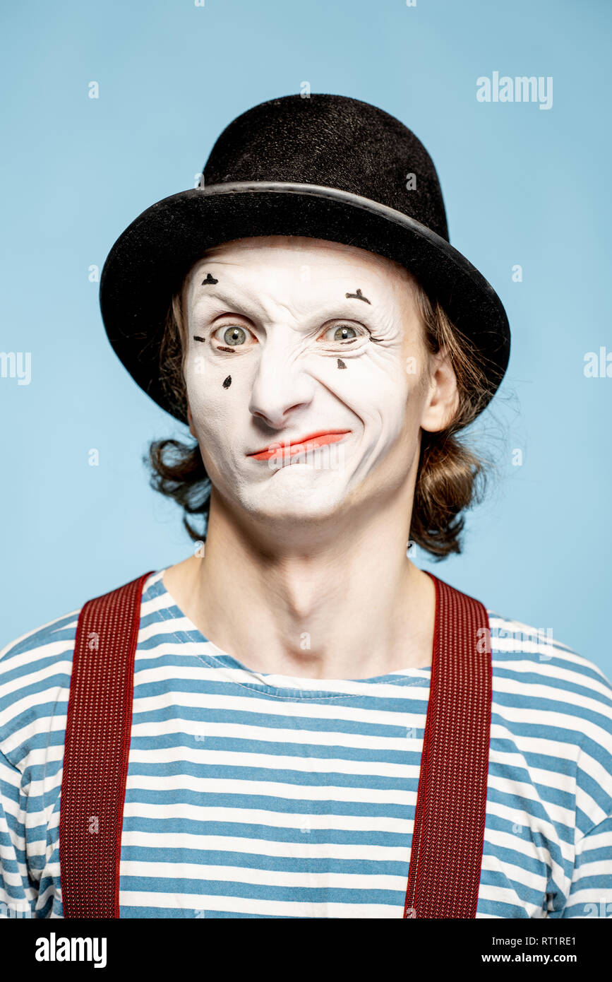 Close-up portrait of an actor as a pantomime with white facial makeup ...