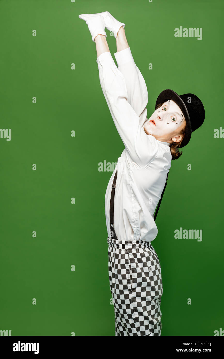 Portrait of an actor as a pantomime with white facial makeup posing ...