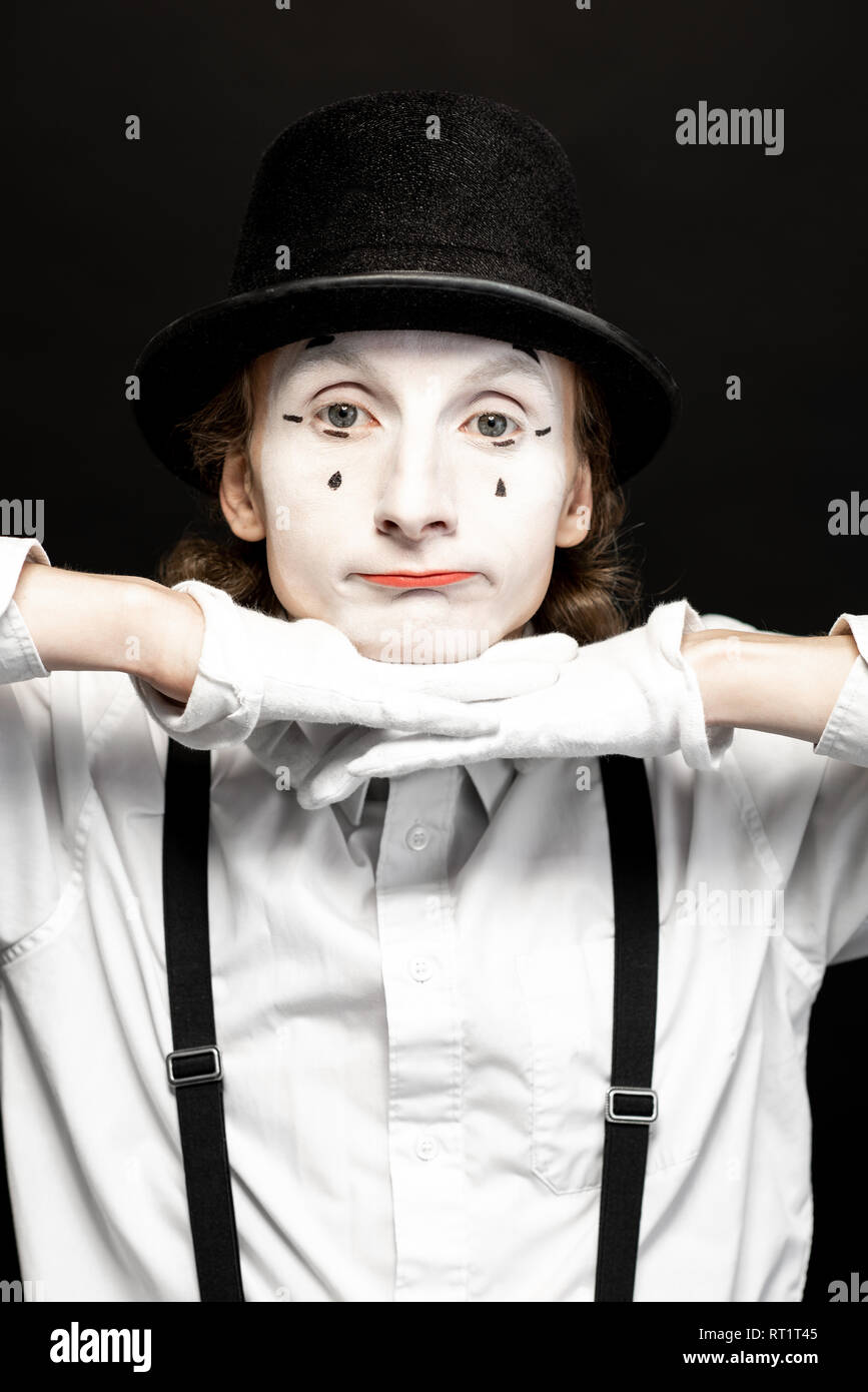 Close-up portrait of a pantomime with white facial makeup posing with ...