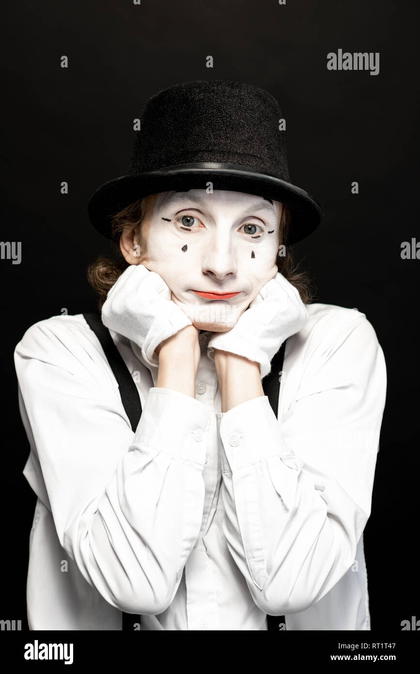 Close-up portrait of a pantomime with white facial makeup posing with ...