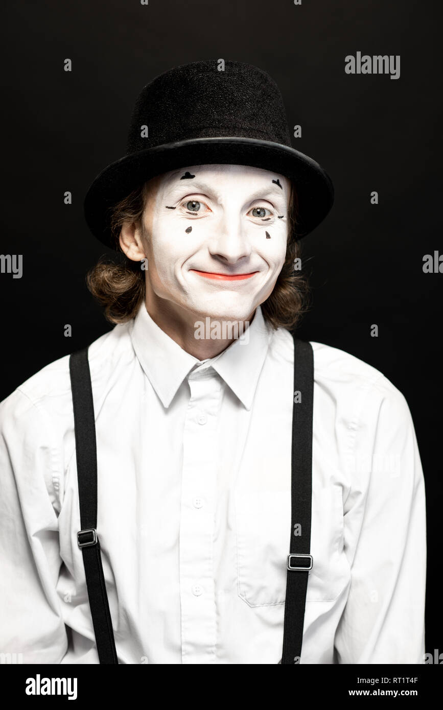 Close-up portrait of a pantomime with white facial makeup posing with ...