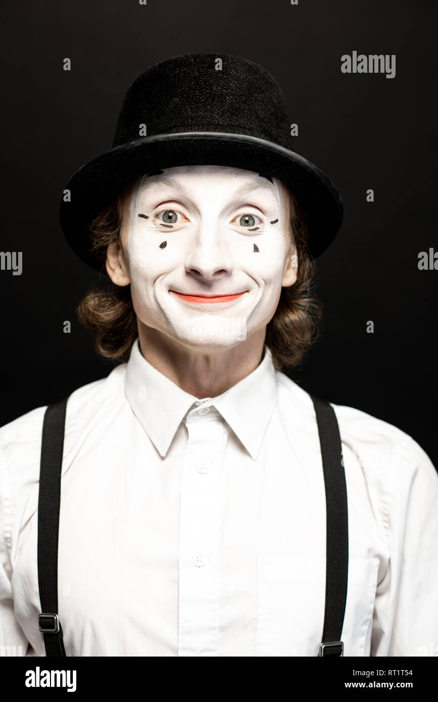 Close-up portrait of a pantomime with white facial makeup posing with ...