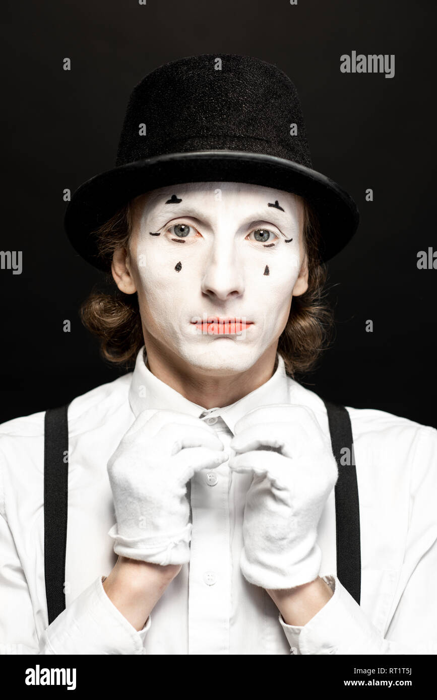 Close-up portrait of a pantomime with white facial makeup posing with ...