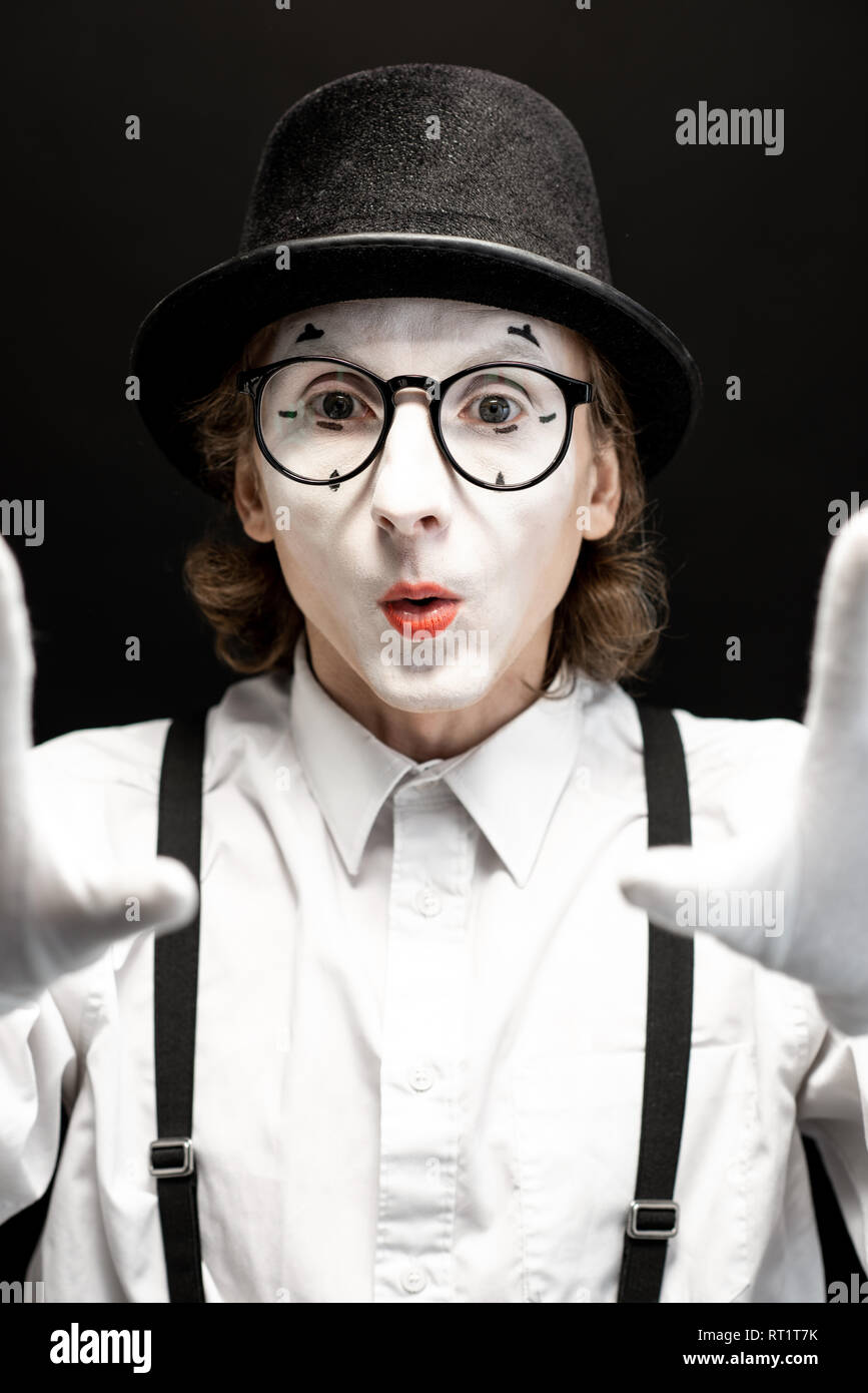 Close-up portrait of a pantomime with white facial makeup posing with ...