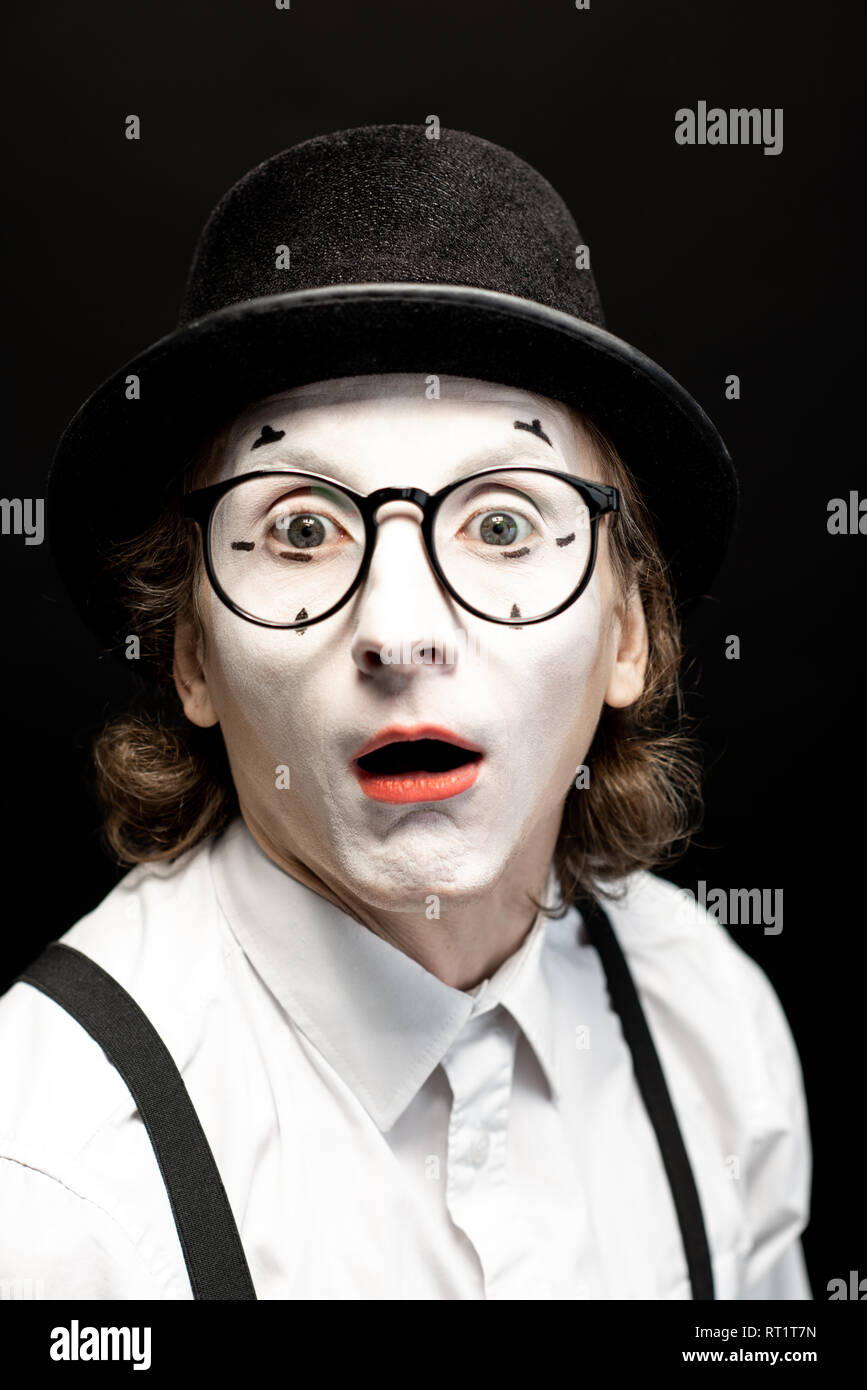 Close-up portrait of a pantomime with white facial makeup posing with ...