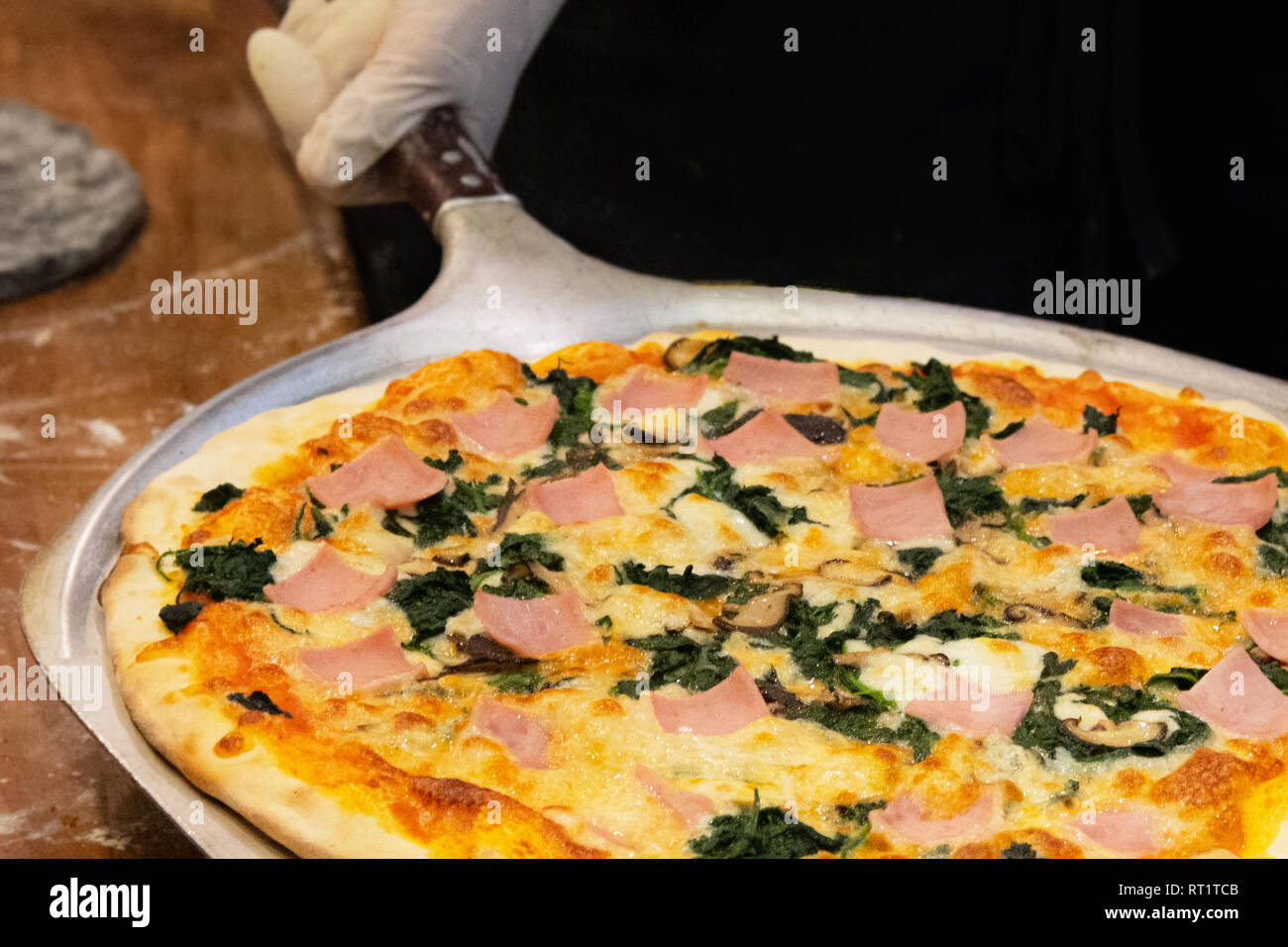 chef prepares delicious pizzas on the kitchen, view from the inside of ...