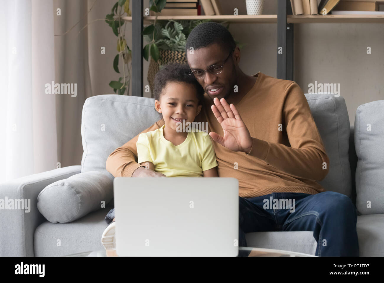 Happy african father and kid son making video call Stock Photo - Alamy