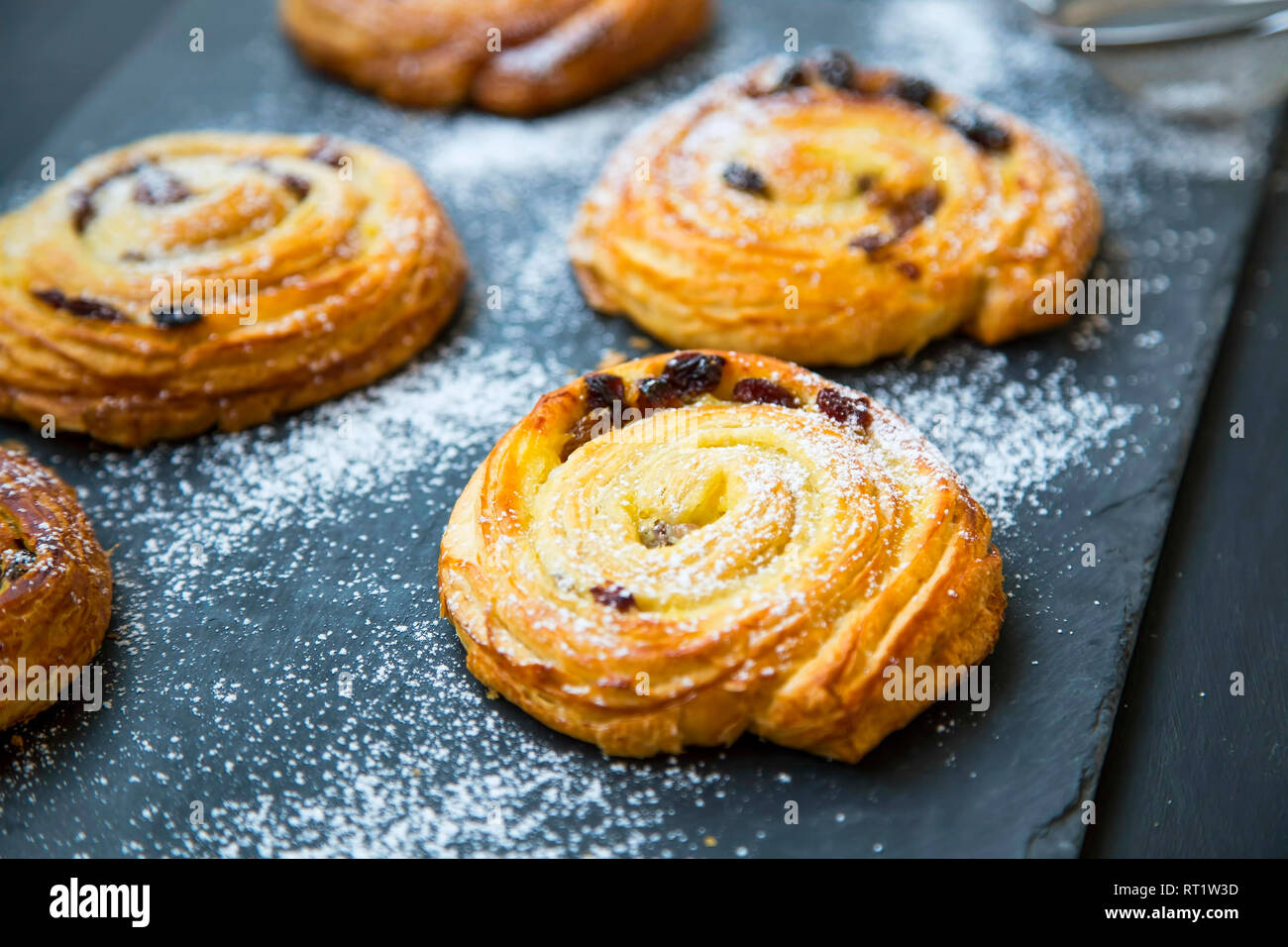 French pastry bun rolls with raisins and vanilla. Pain aux raisins ...