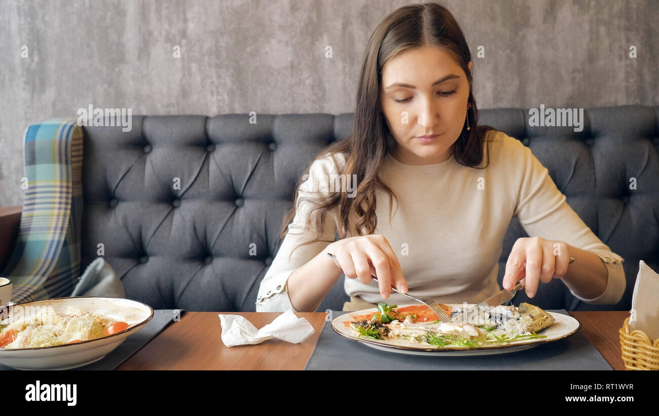 Woman eating salmon fork hi-res stock photography and images - Alamy