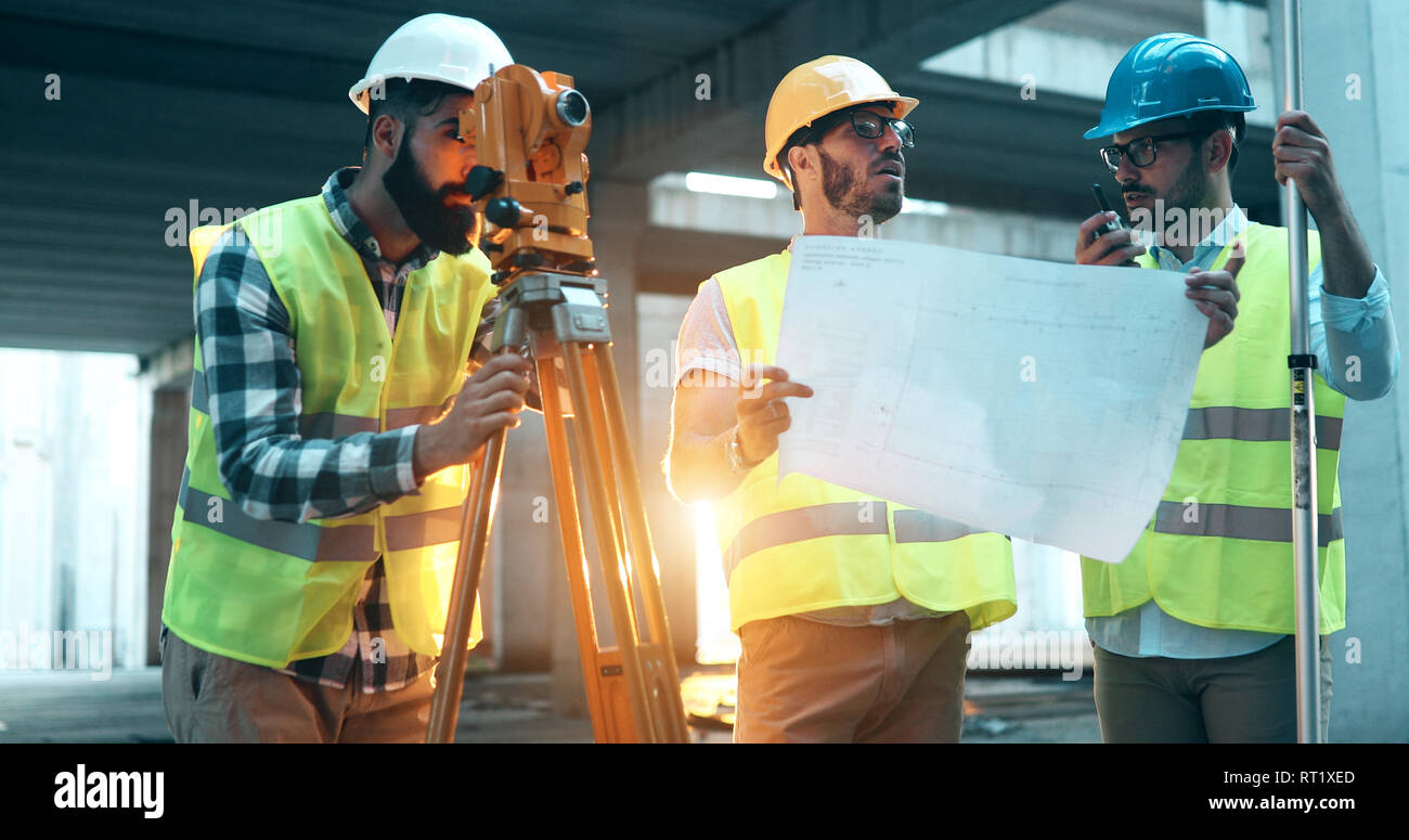 Portrait of construction engineers working on building site Stock Photo ...