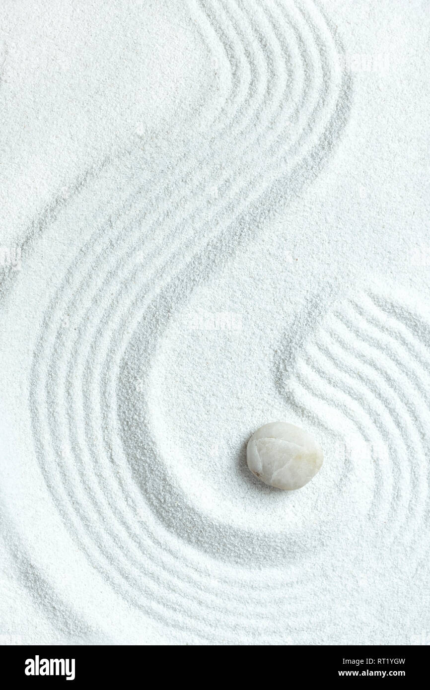 Zen garden with the white sand and a single rock Stock Photo - Alamy
