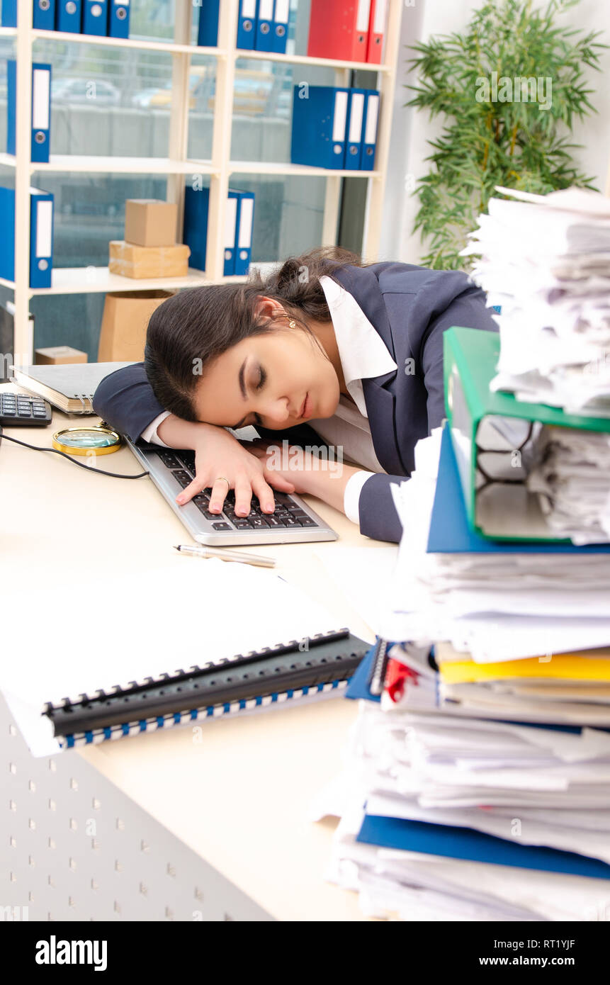Female employee with too much work in the office Stock Photo - Alamy