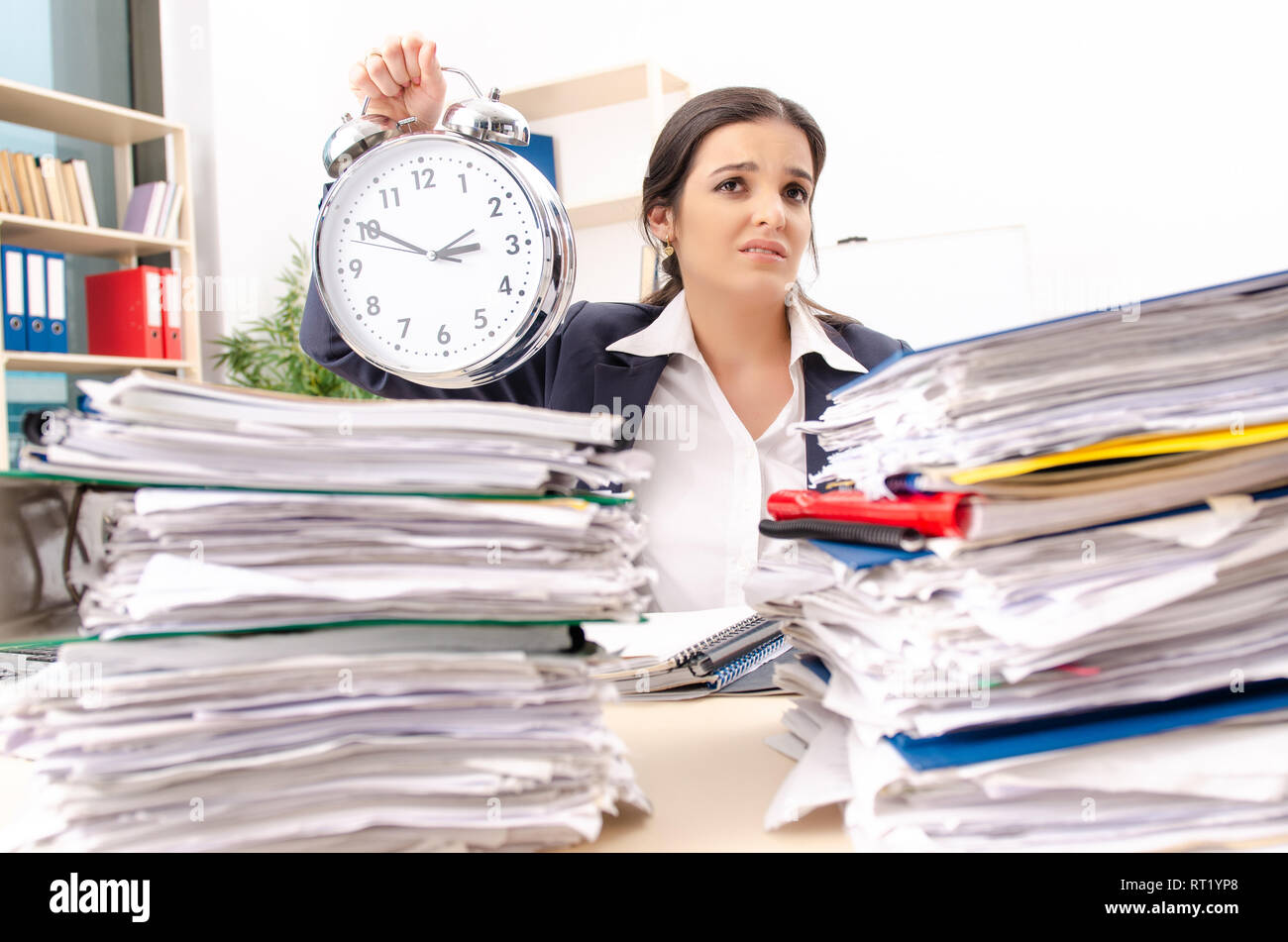 Female employee with too much work in the office Stock Photo - Alamy