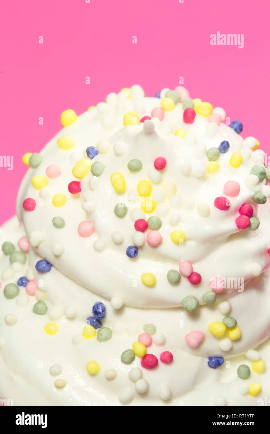 Whipped cream with the colorful sugar sprinkles Stock Photo - Alamy