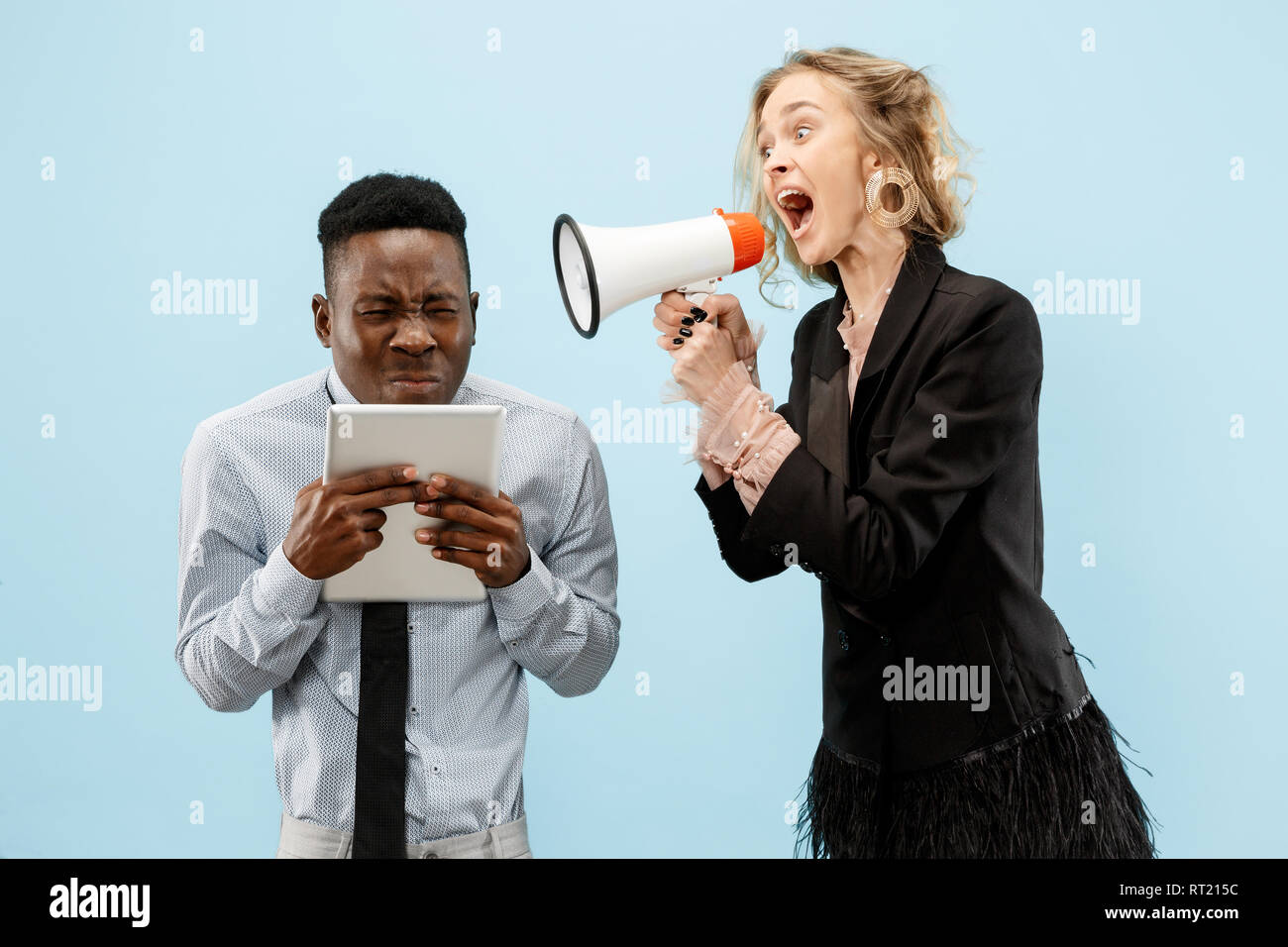 Angry boss. Woman and her secretary standing at office or studio ...