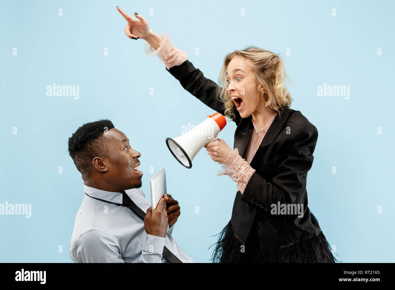 Angry boss. Woman and her secretary standing at office or studio ...