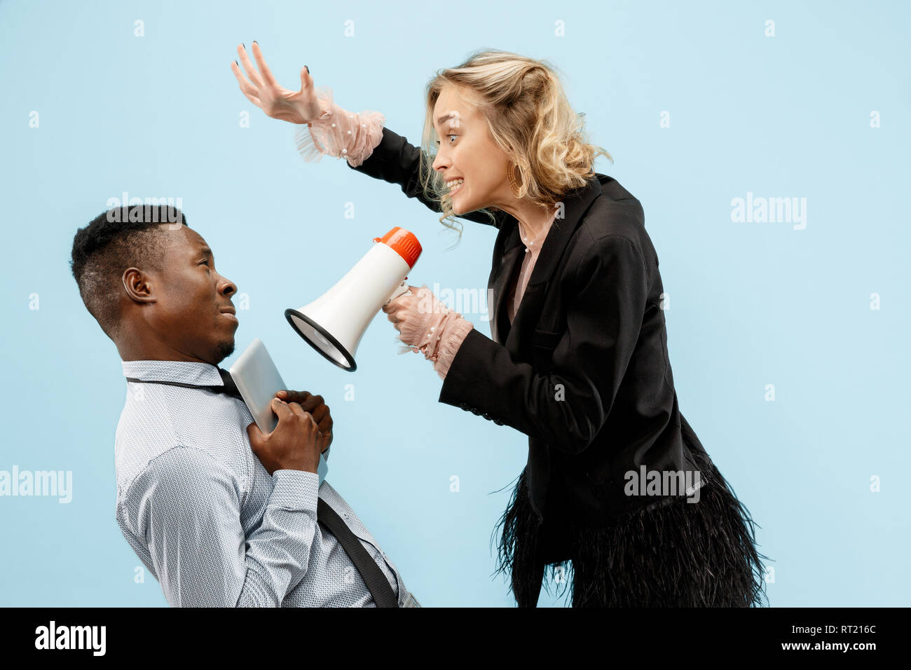 Angry boss. Woman and her secretary standing at office or studio ...