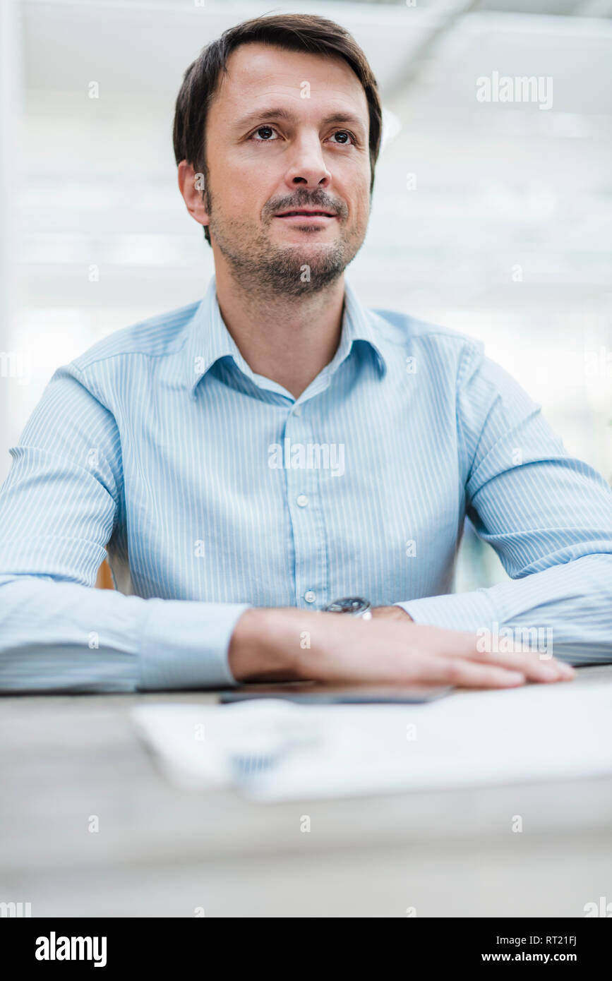 Confident businessman sitting desk office thinking hi-res stock ...