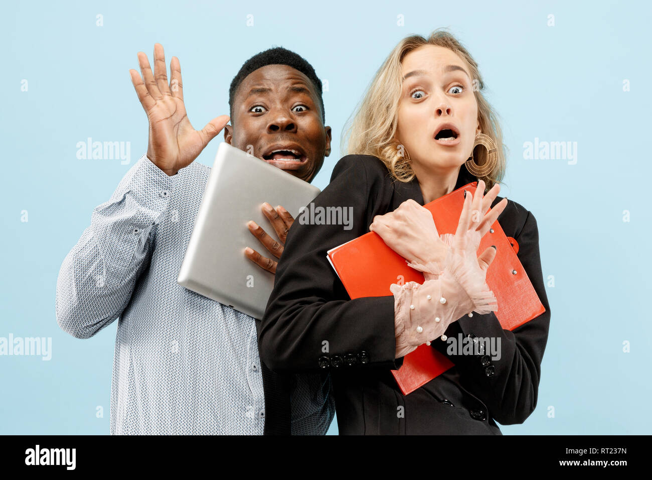 We are afraid. Fright. Portrait of the scared mixed couple. The ...