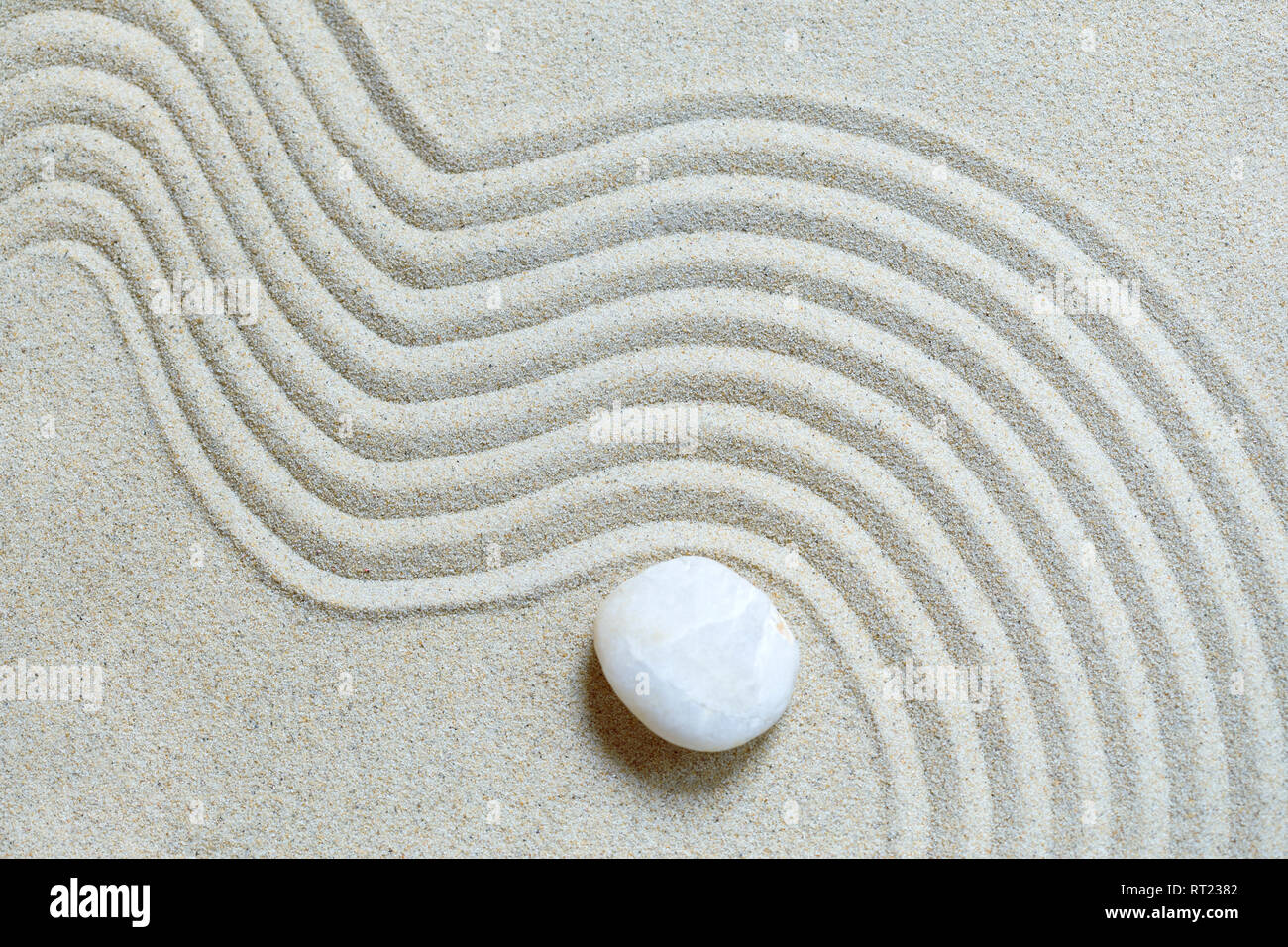 Zen garden with sand pattern and the single stone Stock Photo - Alamy