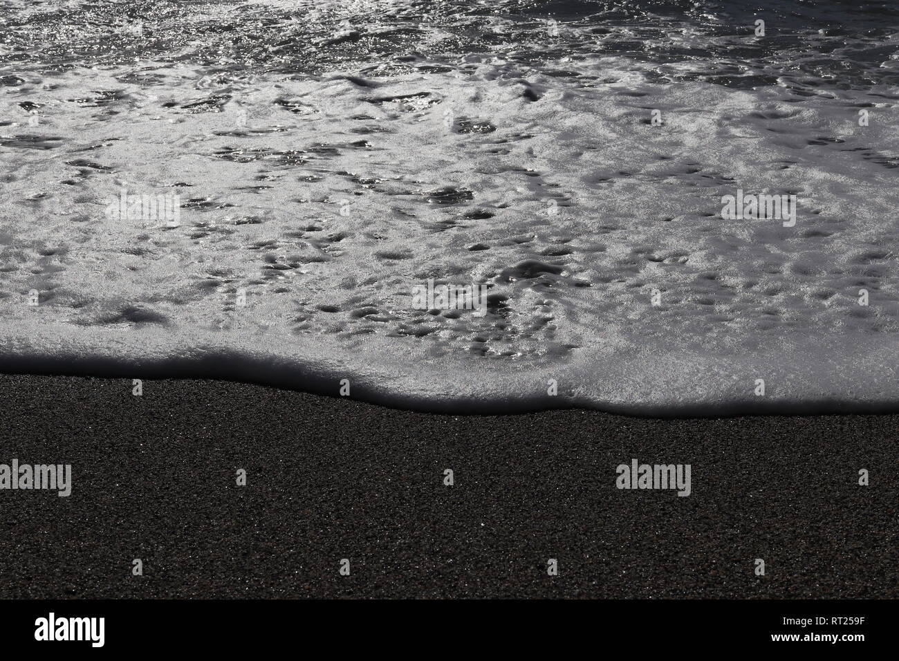 Sand beach with wave foam. Sea beauty background Stock Photo - Alamy