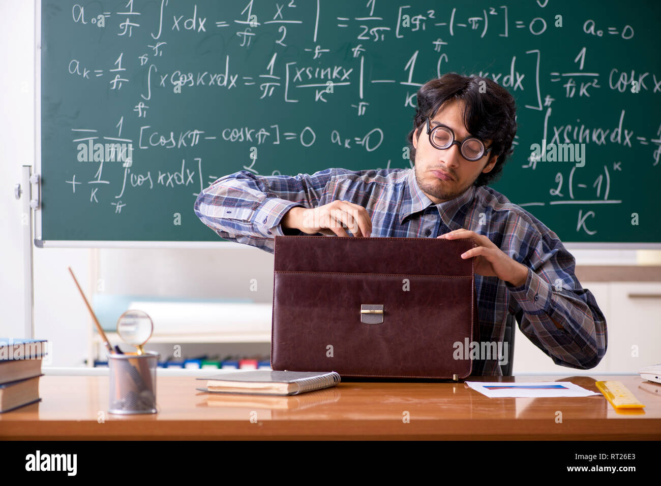 Funny male math teacher in the classroom Stock Photo - Alamy