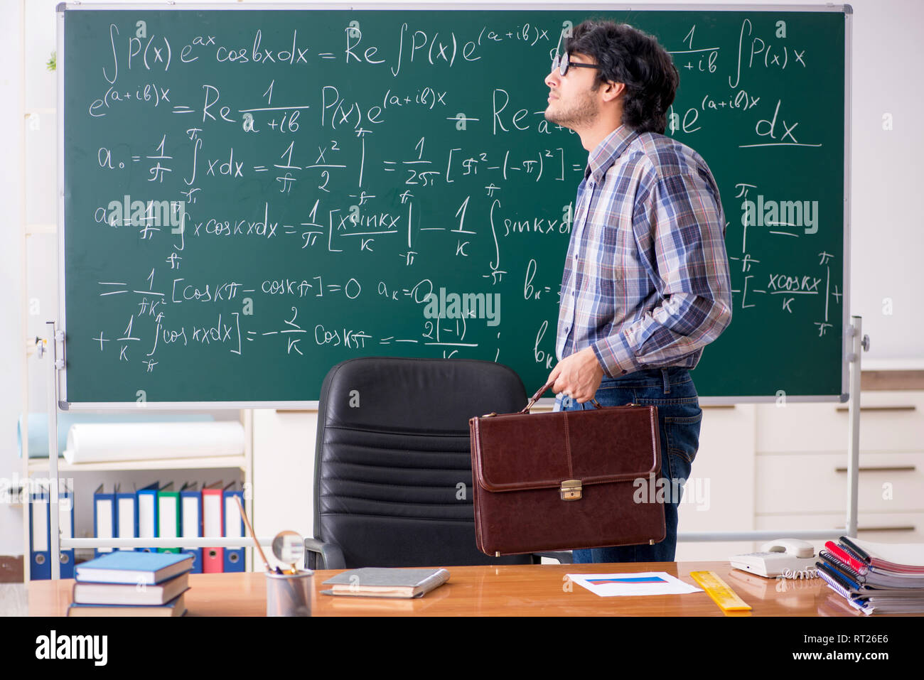 Funny male math teacher in the classroom Stock Photo - Alamy