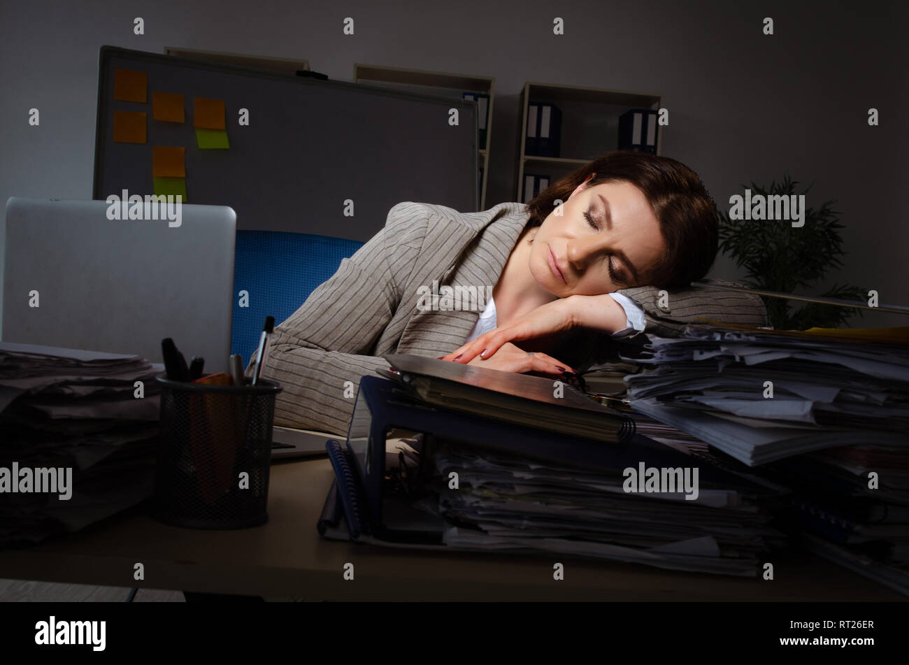 Female employee suffering from excessive work Stock Photo - Alamy