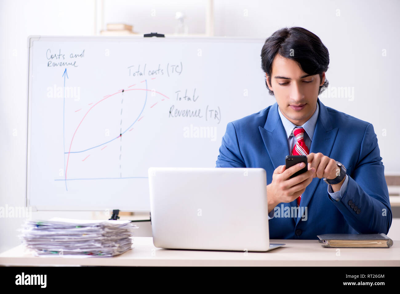 Busy businessman explaining business charts Stock Photo - Alamy