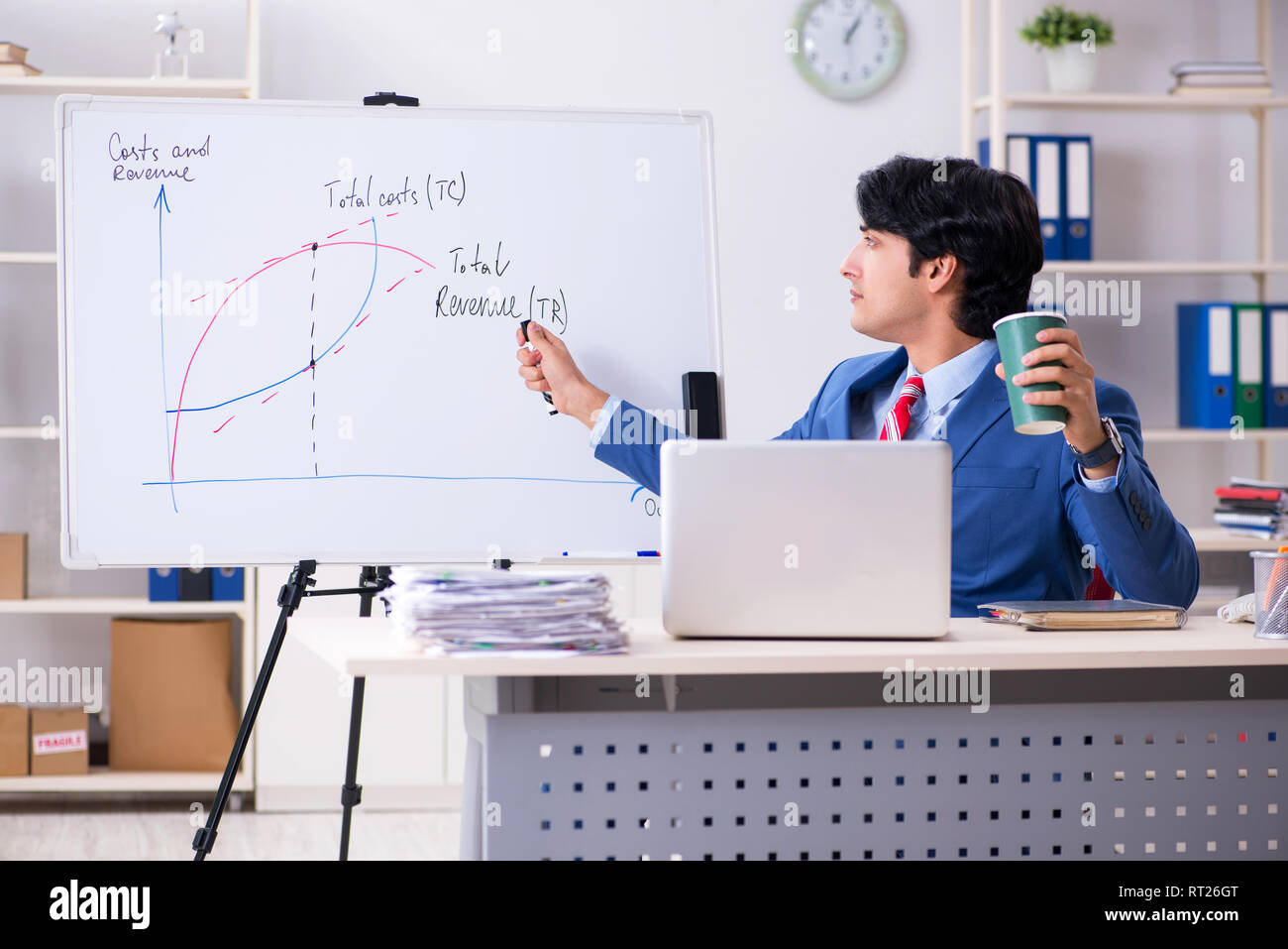 Busy businessman explaining business charts Stock Photo - Alamy